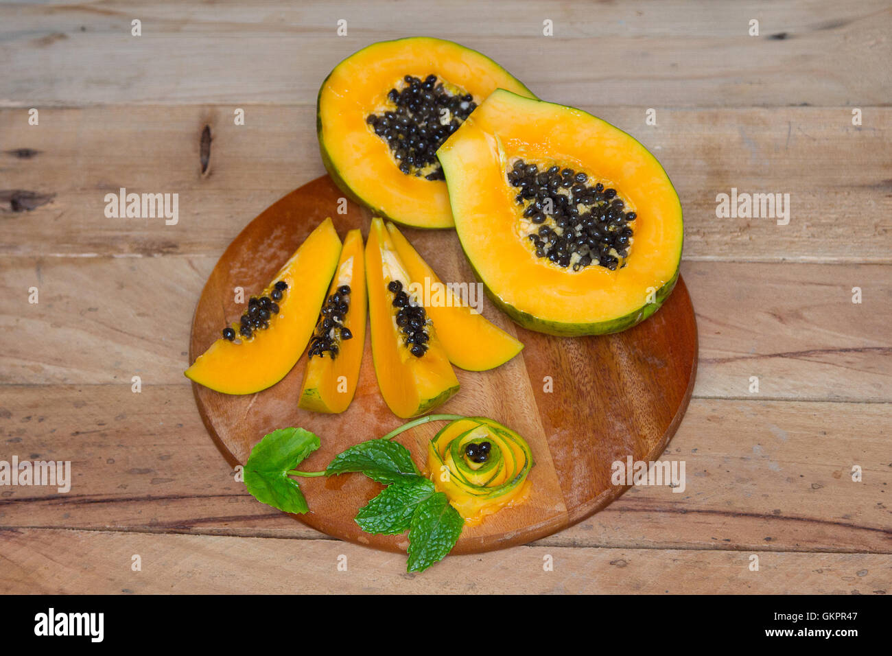 Ripe sweet papaya on green background Stock Photo - Alamy