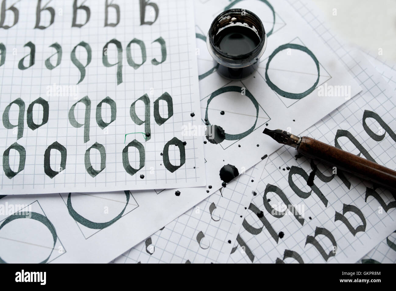 Antique calligraphy pens and ink blots with fancy writing on paper ...