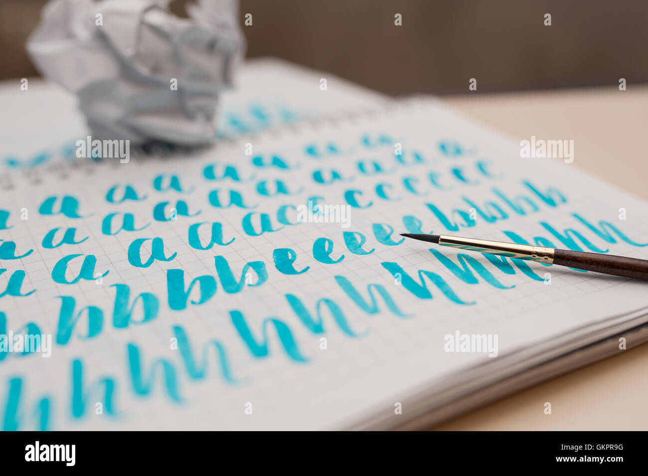 Notebook with calligraphy Lettering and brush Stock Photo - Alamy