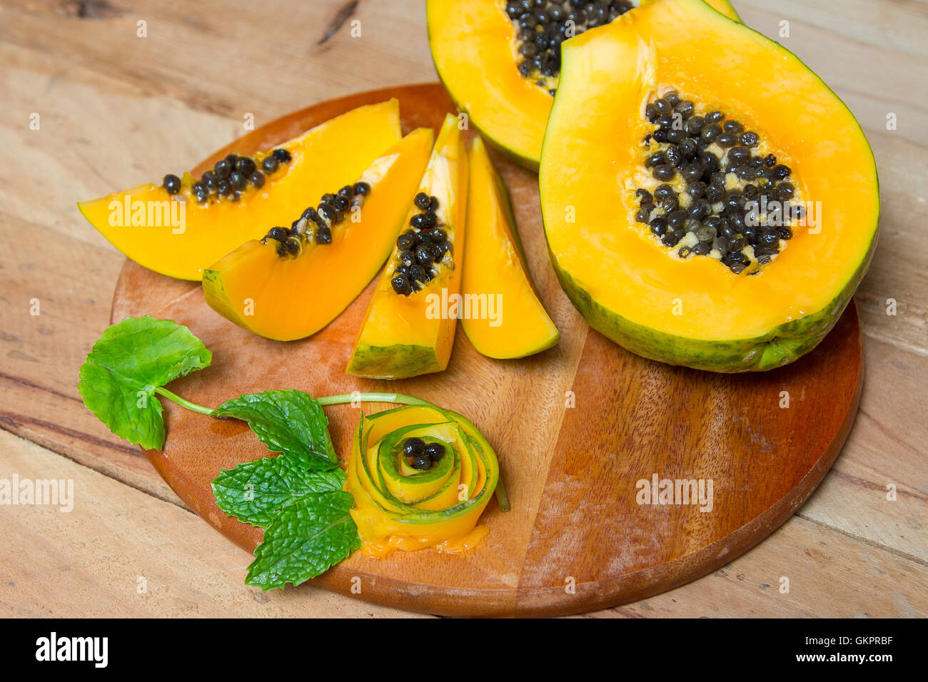 Sliced fresh papaya. Papaya fruit on wooden background Stock Photo - Alamy