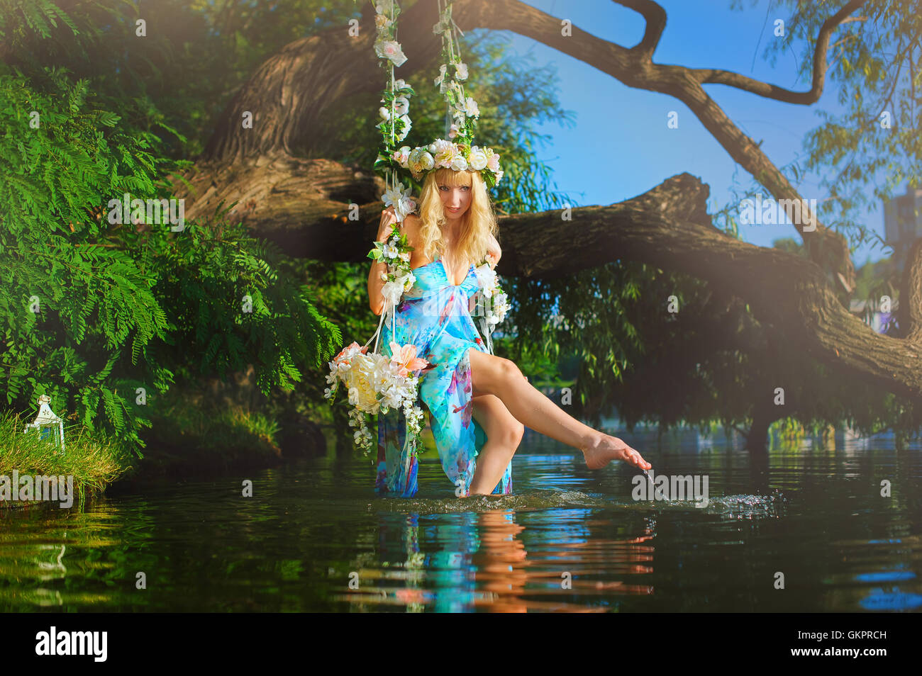 Woman on swing over river Stock Photo - Alamy