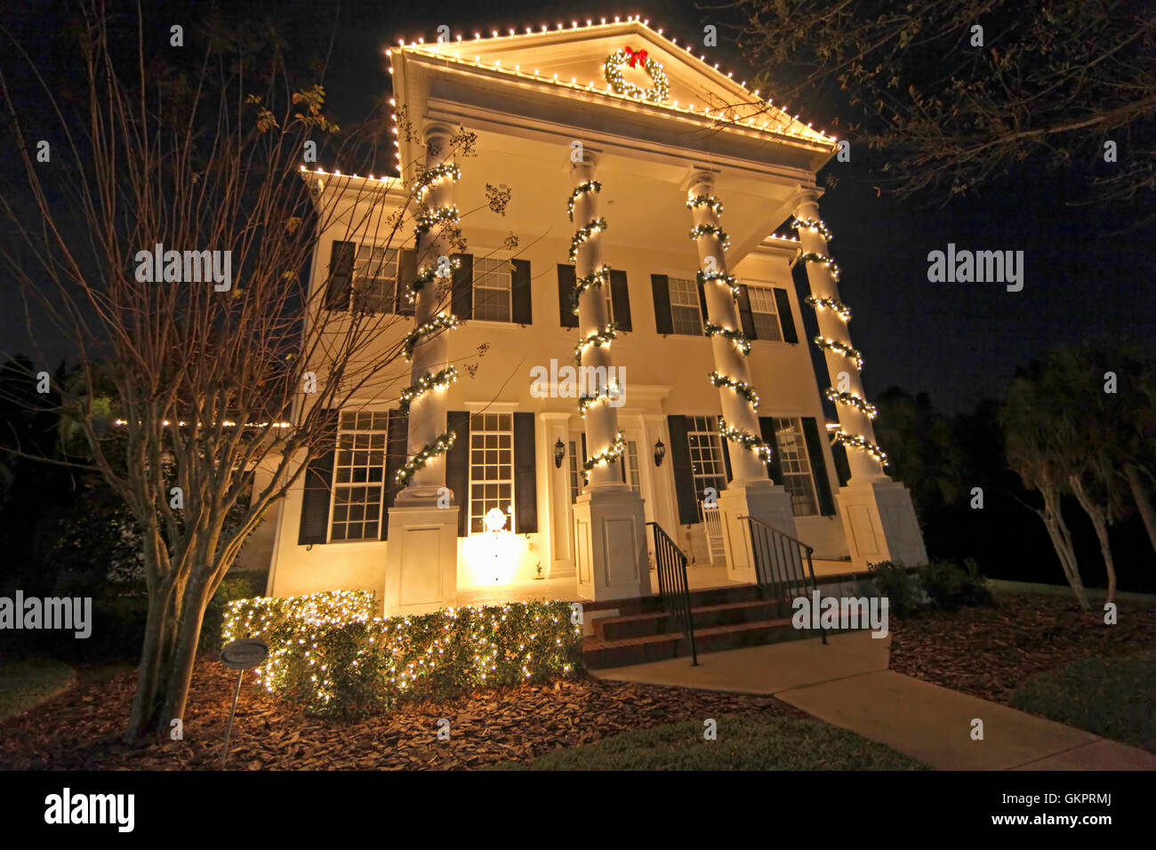 A Colonial House with a lot of Christmas Lights Stock Photo - Alamy