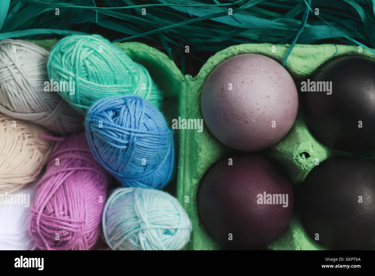 Colored in purple eggs with yarn still life Stock Photo - Alamy