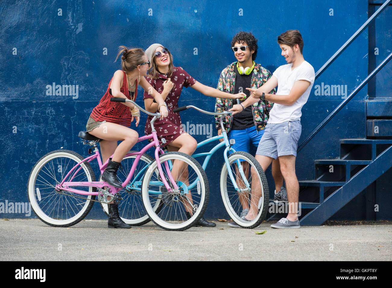 Four friends get together at park having fun and talking Stock Photo ...