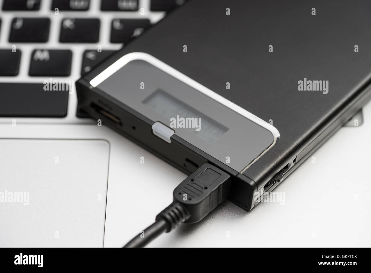 External hard disk over laptop keyboard Stock Photo - Alamy