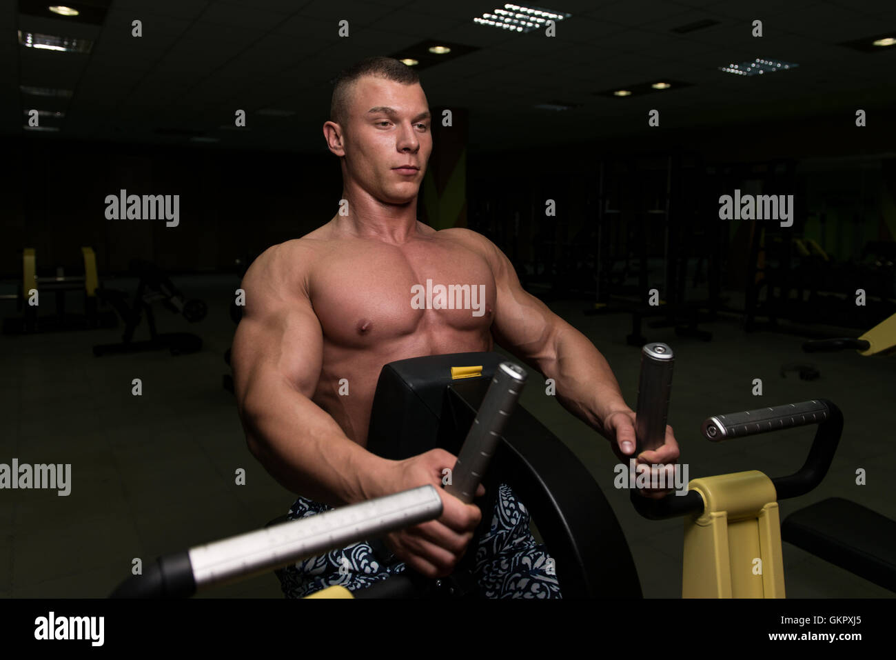 Muscular Athletic Bodybuilder Fitness Model Doing Heavy Weight Exercise ...