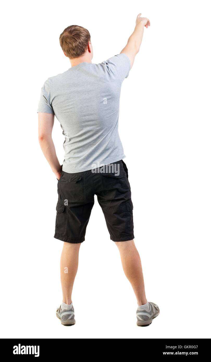 Back view of handsome man in t-shirt and shorts pointing Stock Photo ...