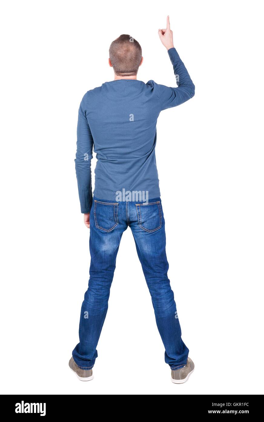 Back view of pointing young men in shirt and jeans Stock Photo - Alamy