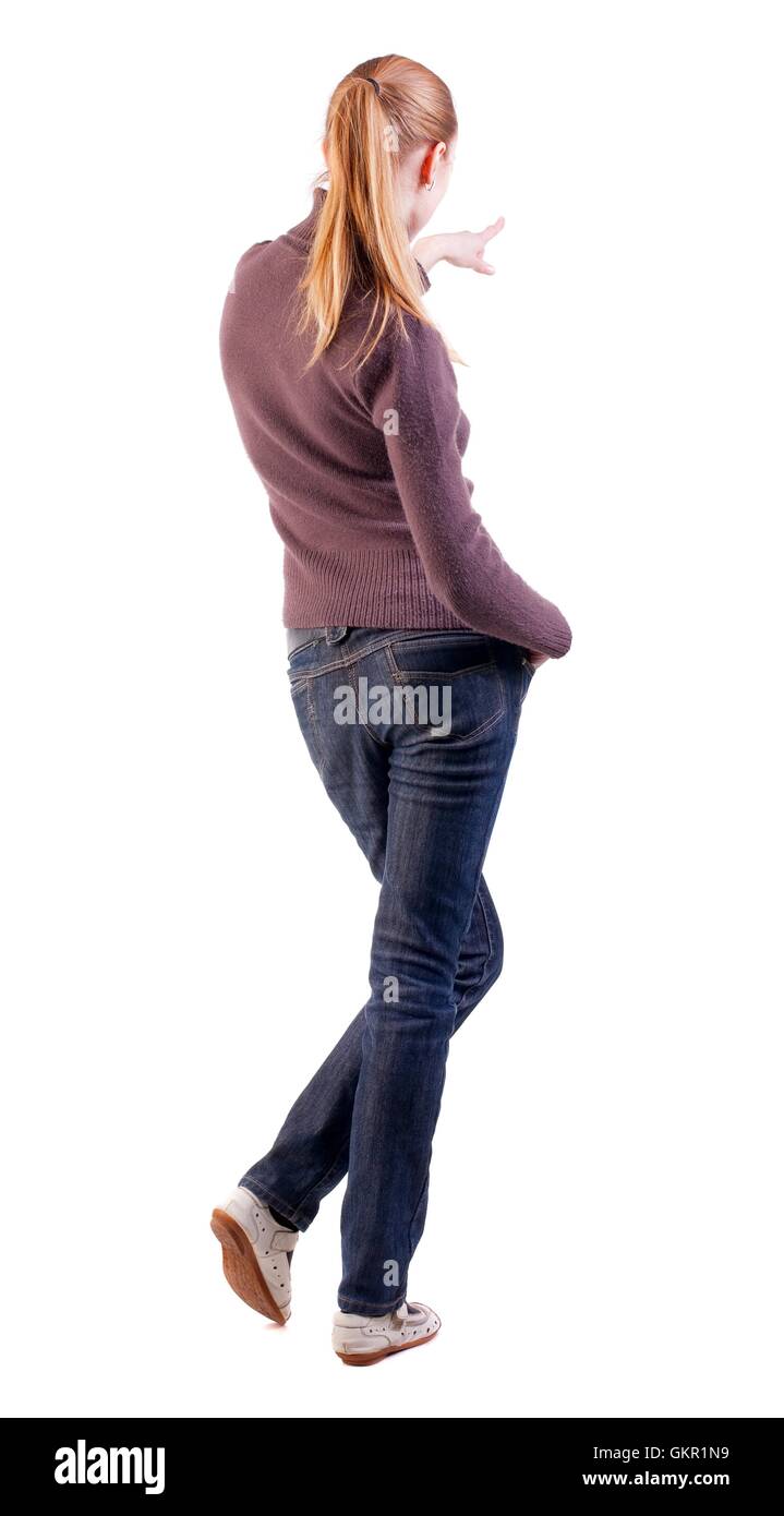 Back view of pointing woman. beautiful blonde girl in jeans Stock Photo ...