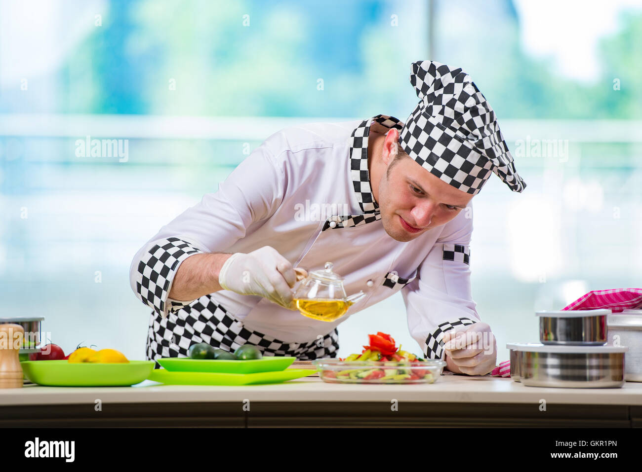 Male cook preparing food in the kitchen Stock Photo - Alamy