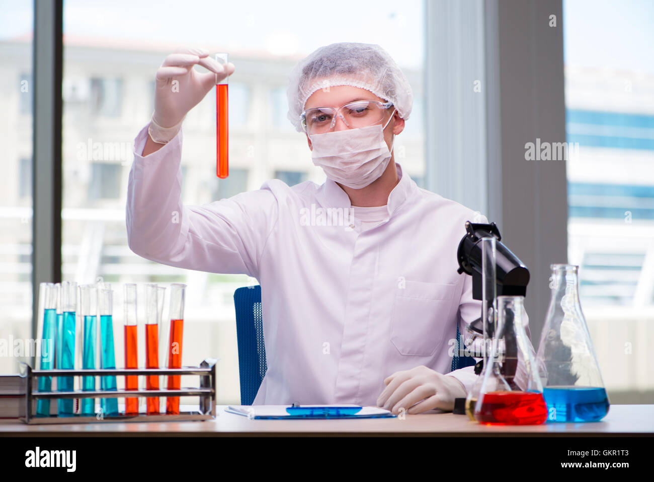 Man working in the chemical lab on science project Stock Photo - Alamy