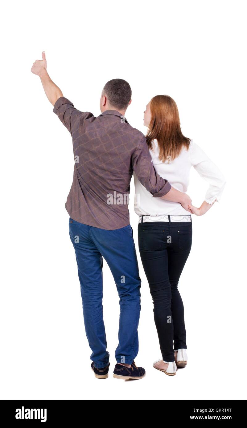 young couple pointing at wal Back view Stock Photo - Alamy