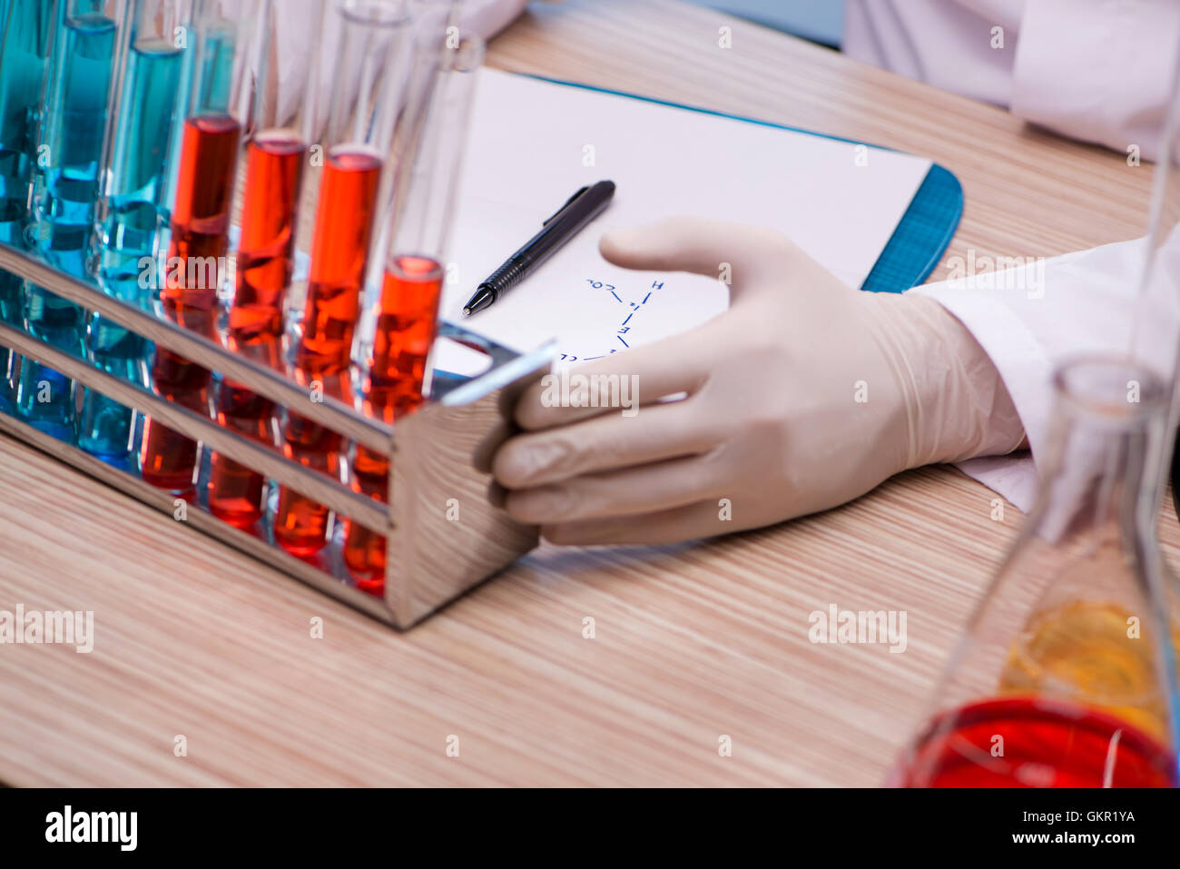 Man working in the chemical lab on science project Stock Photo - Alamy