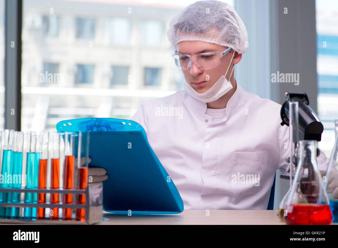 Man working in the chemical lab on science project Stock Photo - Alamy