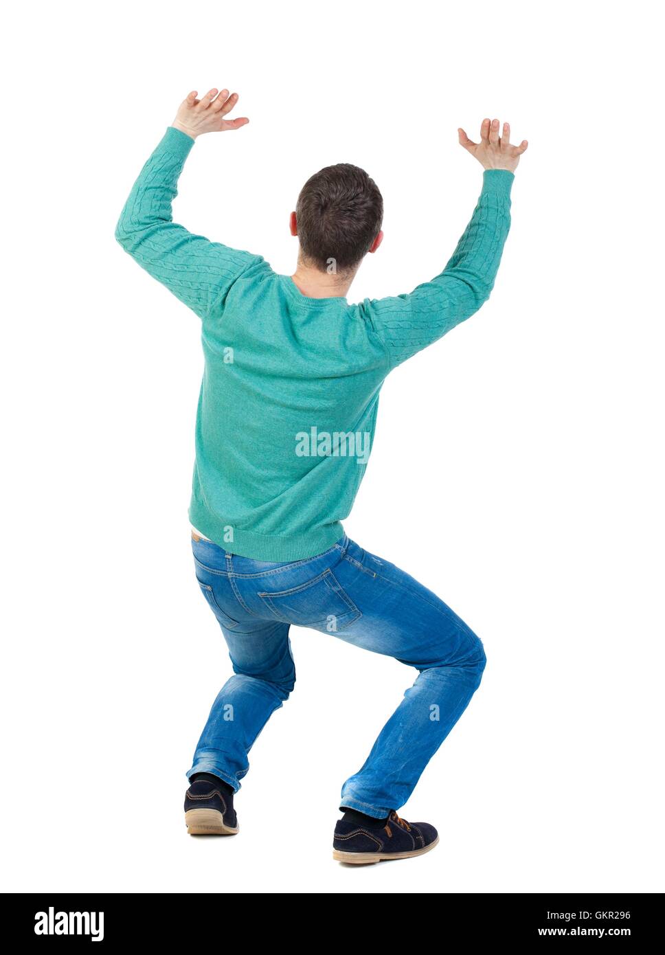 back view. man protects hands from what is falling from above Stock ...