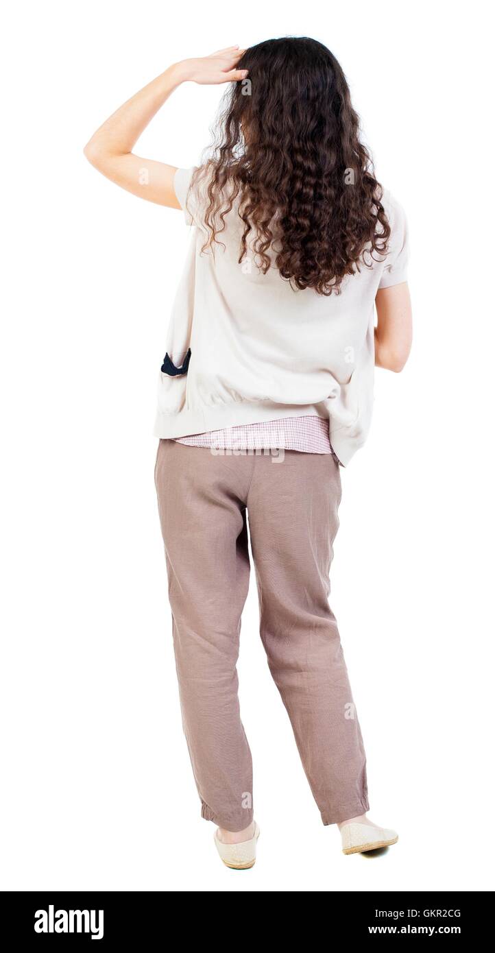 back view of standing young beautiful woman. girl watching Stock Photo ...