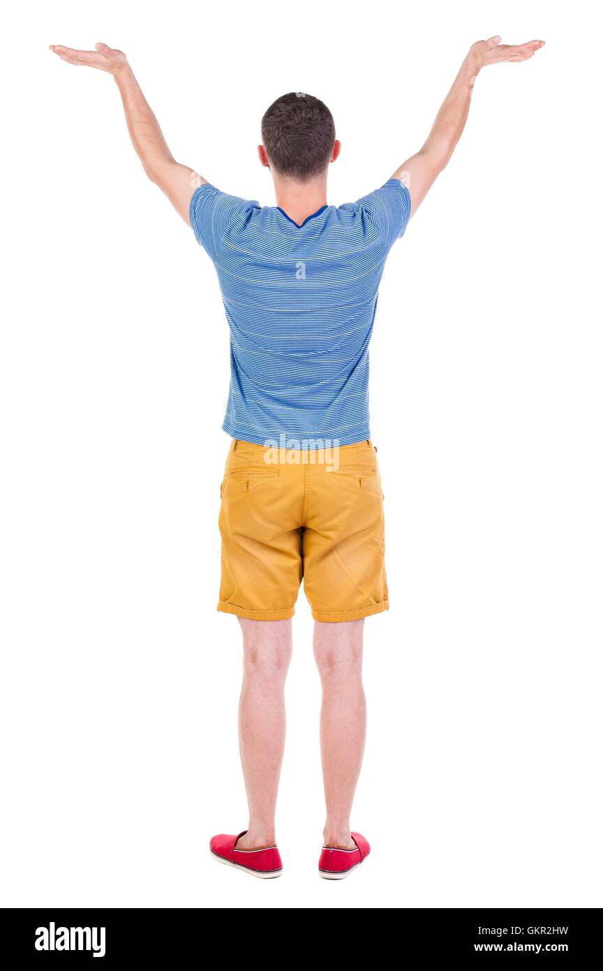 Back view of Beautiful man in jeans looking at wall and Holds h Stock ...