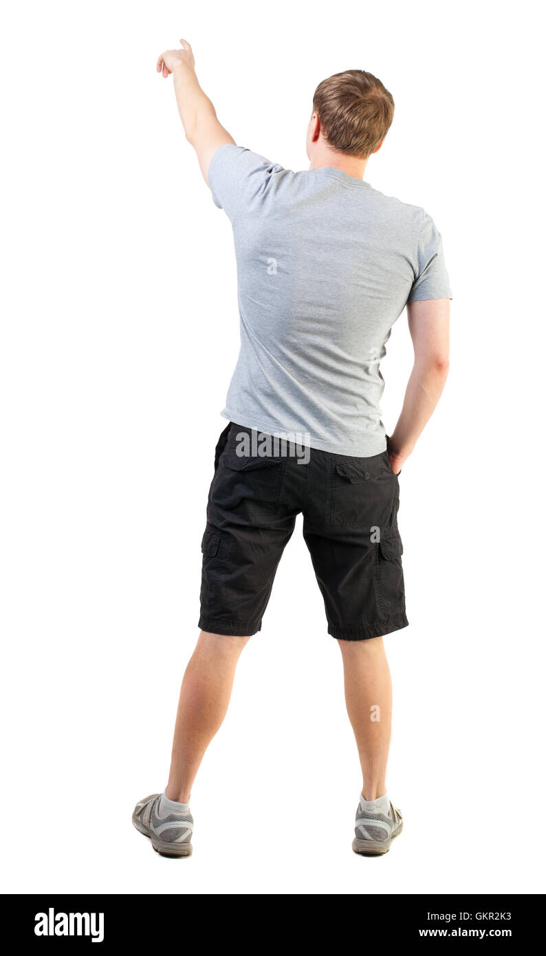 Back view of handsome man in t-shirt and shorts pointing Stock Photo ...