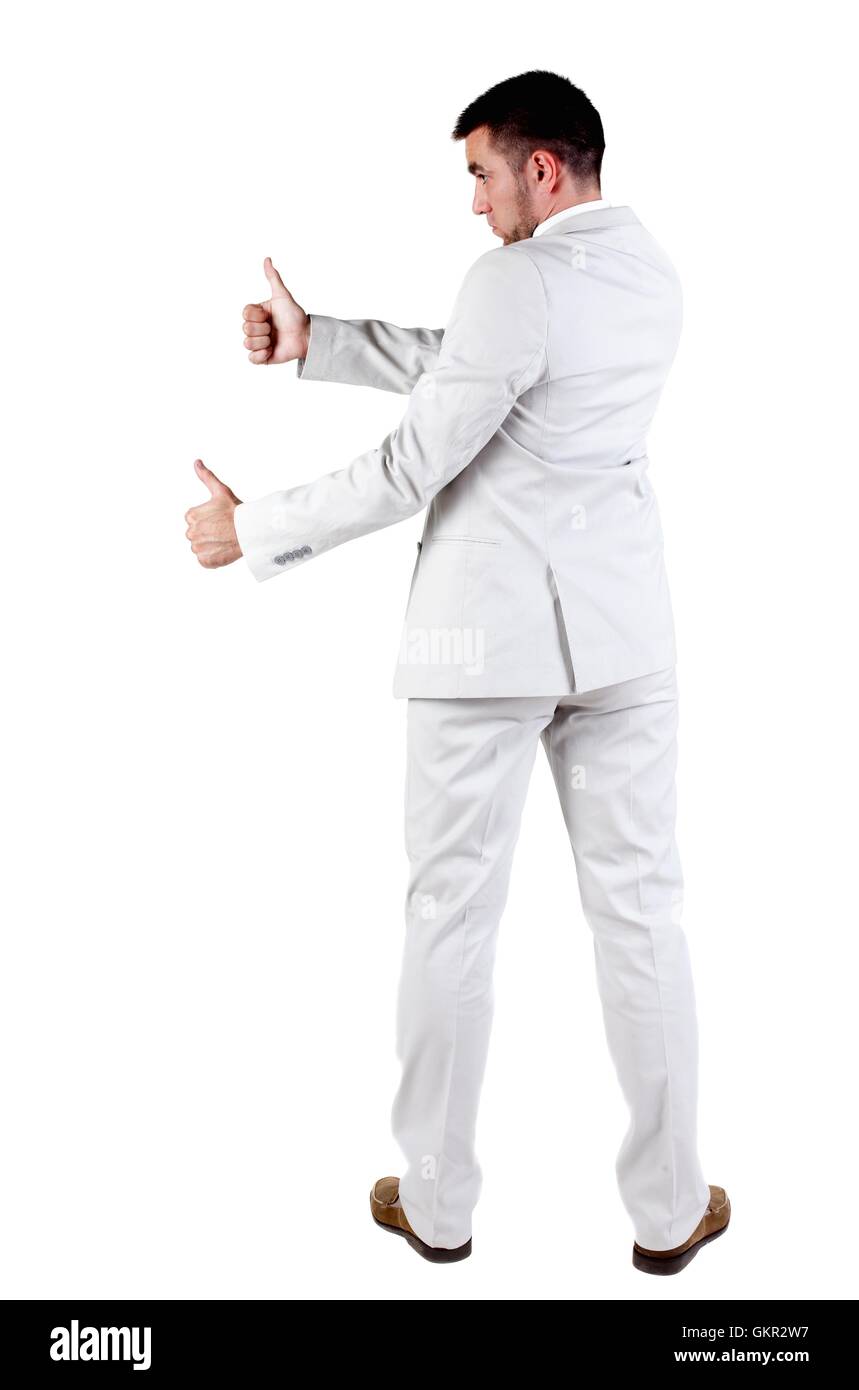 Back view of young business man in white suit going thumb up Stock ...