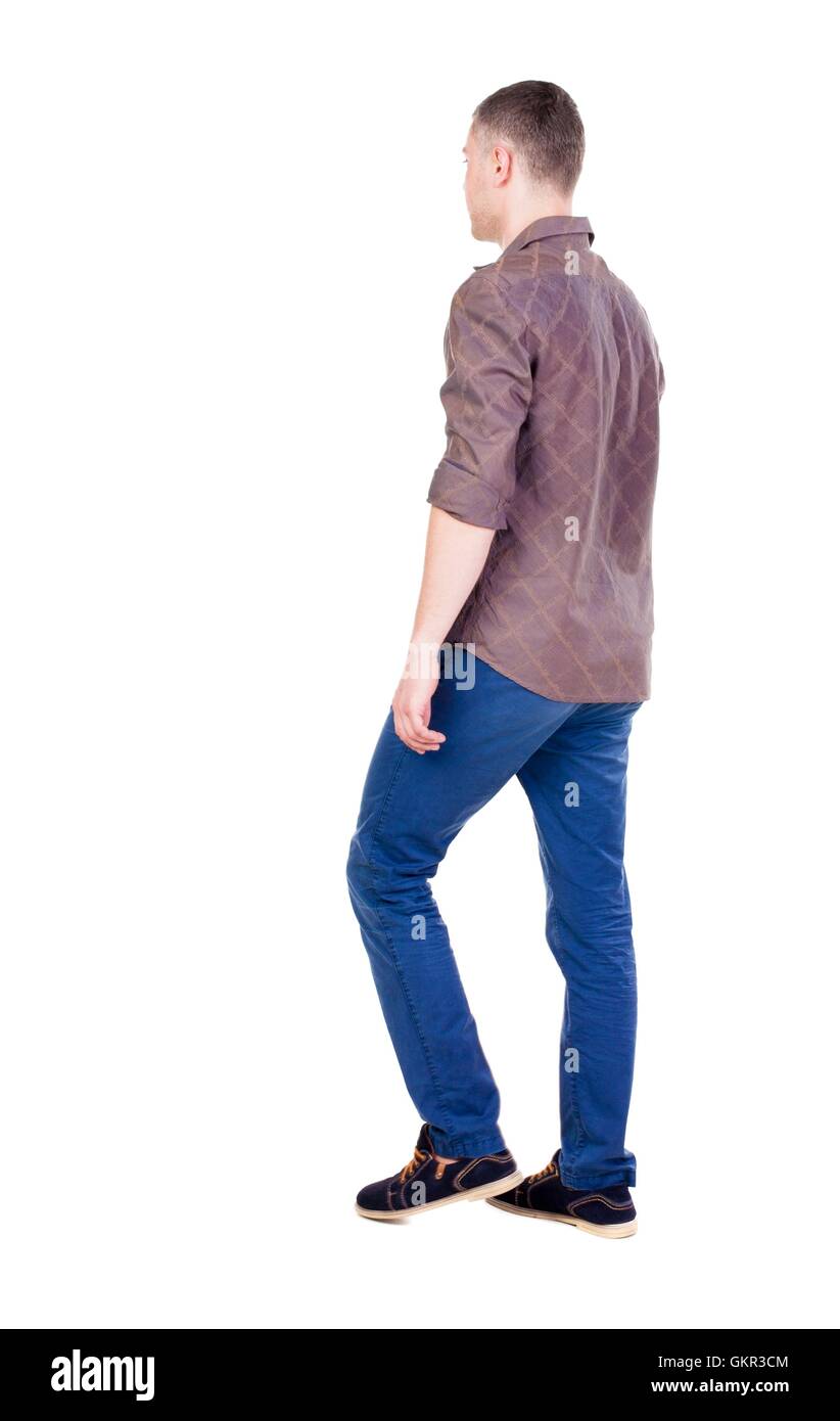 Back view of going handsome man in jeans and a shirt Stock Photo - Alamy