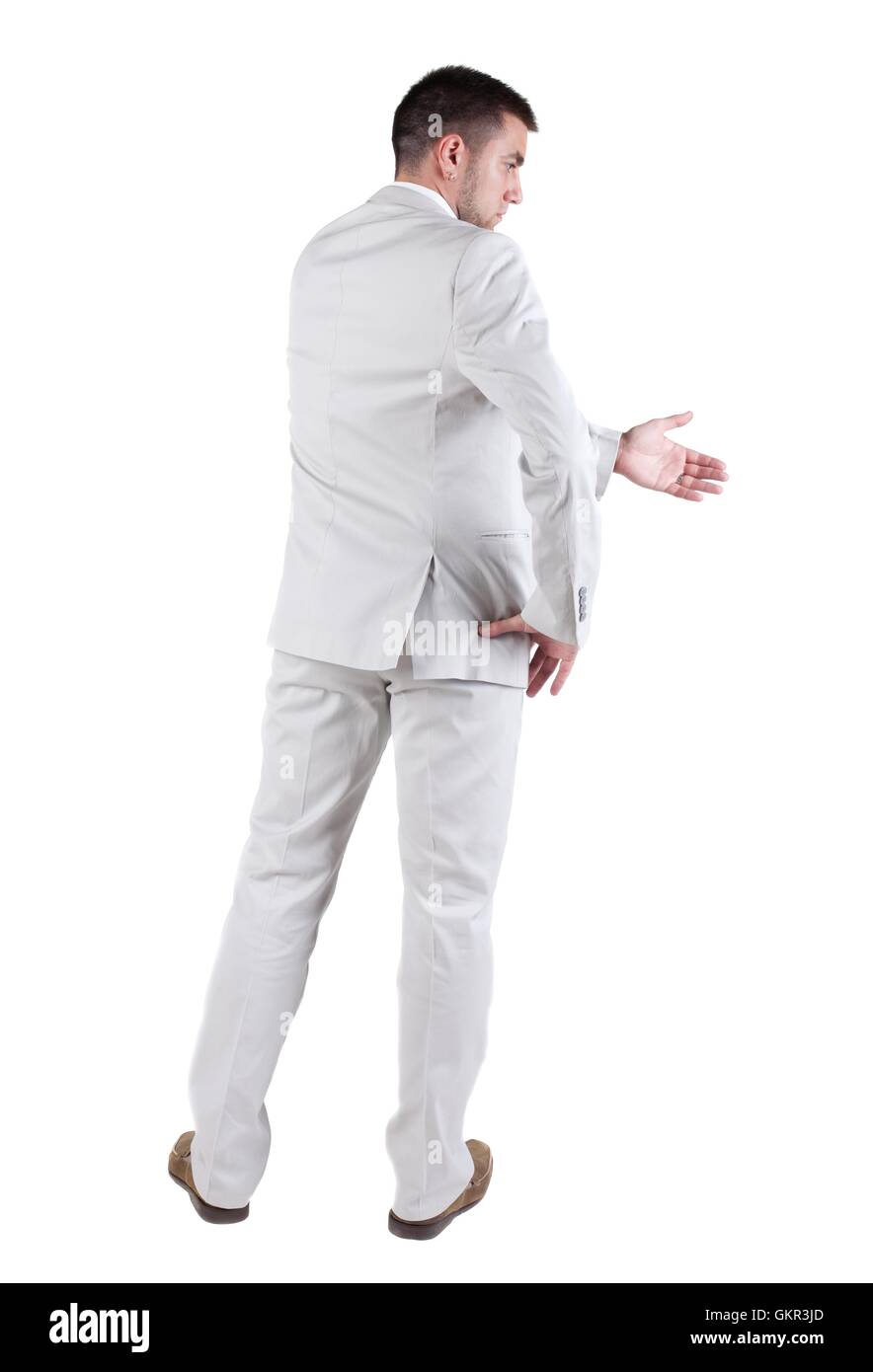 businessman extending hand to shake. Rear view Stock Photo - Alamy