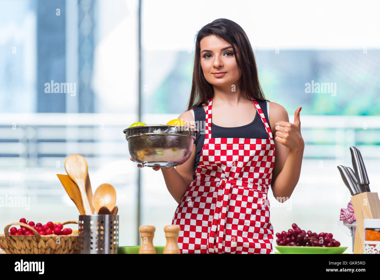 Young cook with fruits in the kitchen Stock Photo - Alamy