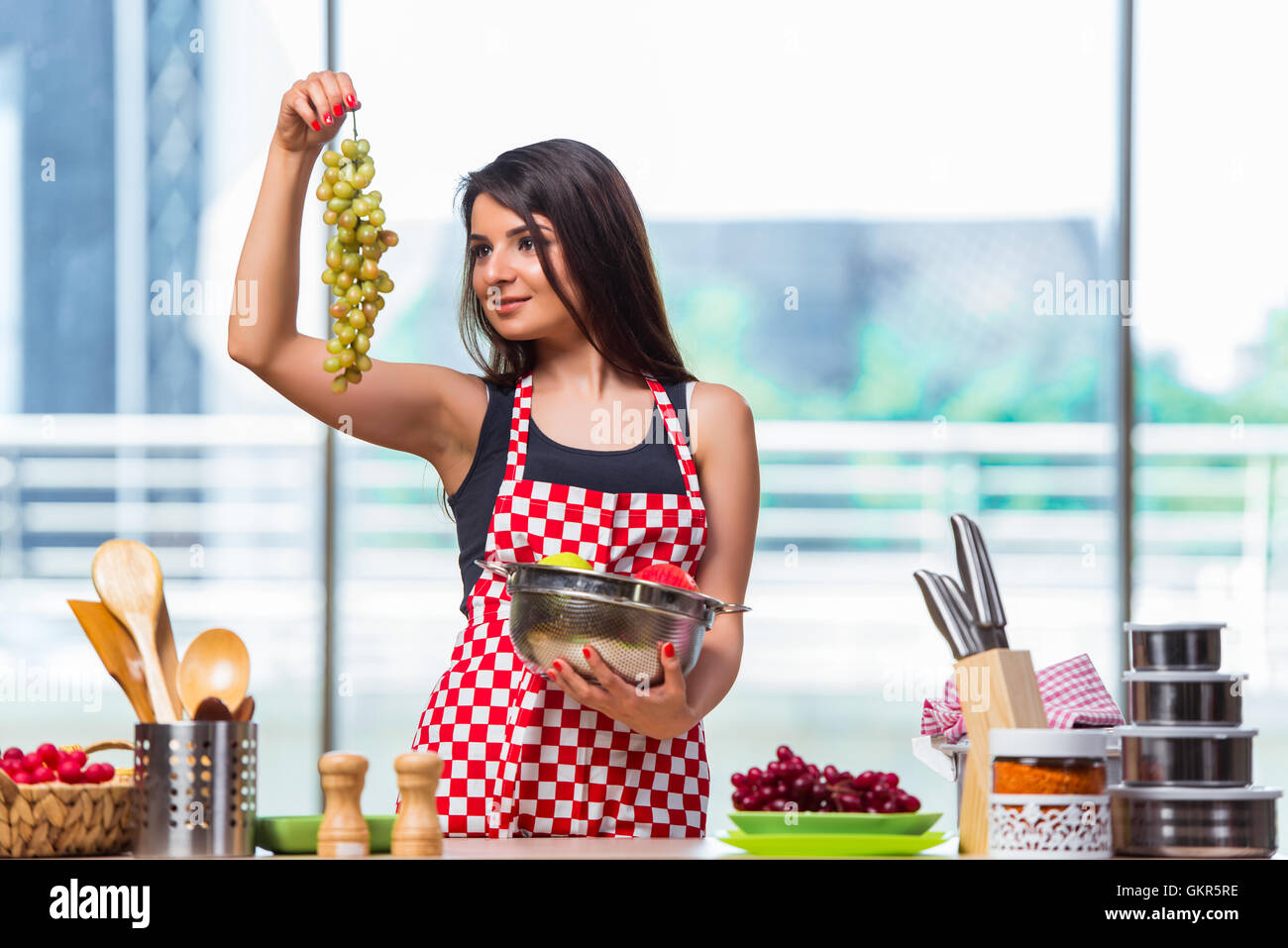 Young cook with fruits in the kitchen Stock Photo - Alamy