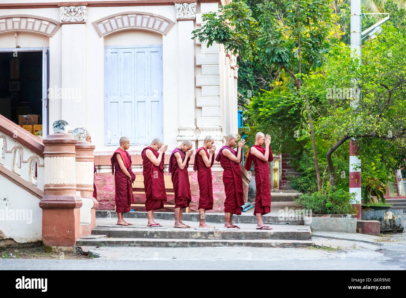 Buddhist monks at an evening prayer ceremony entering Shwe Kyin ...