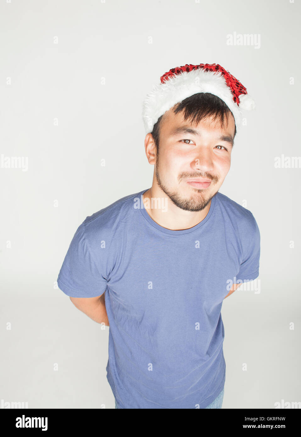 funy exotical asian Santa claus in new years red hat smiling Stock ...