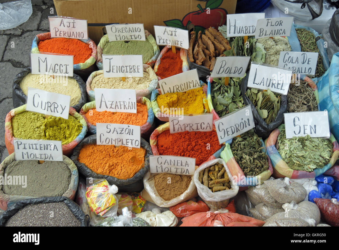 Different bags of colored spices displayed at the andean market of ...