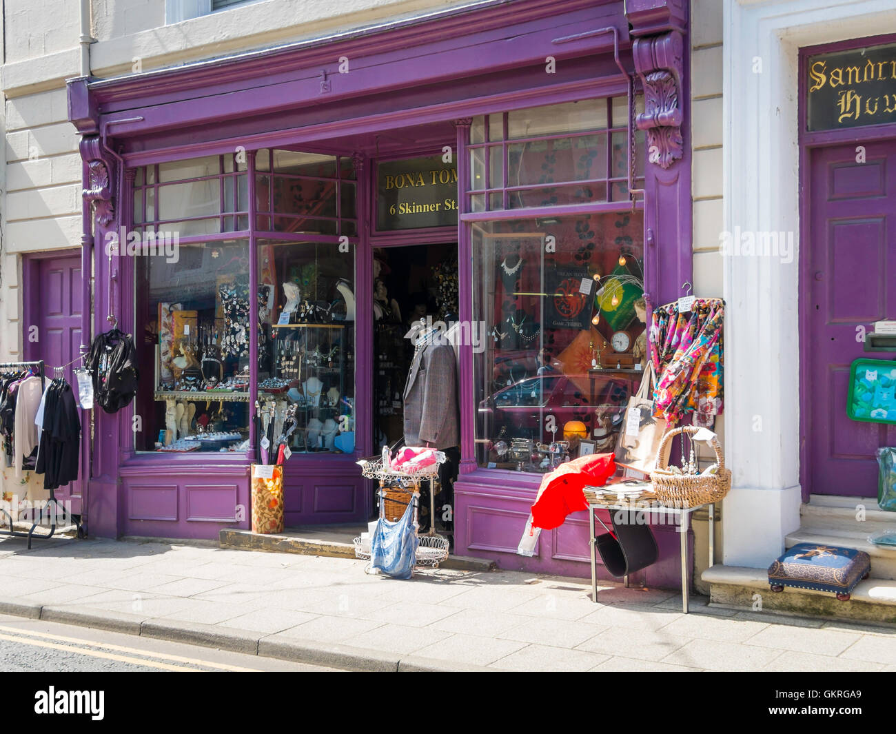 An antique and curio shop with elegant clothing on display Stock Photo ...