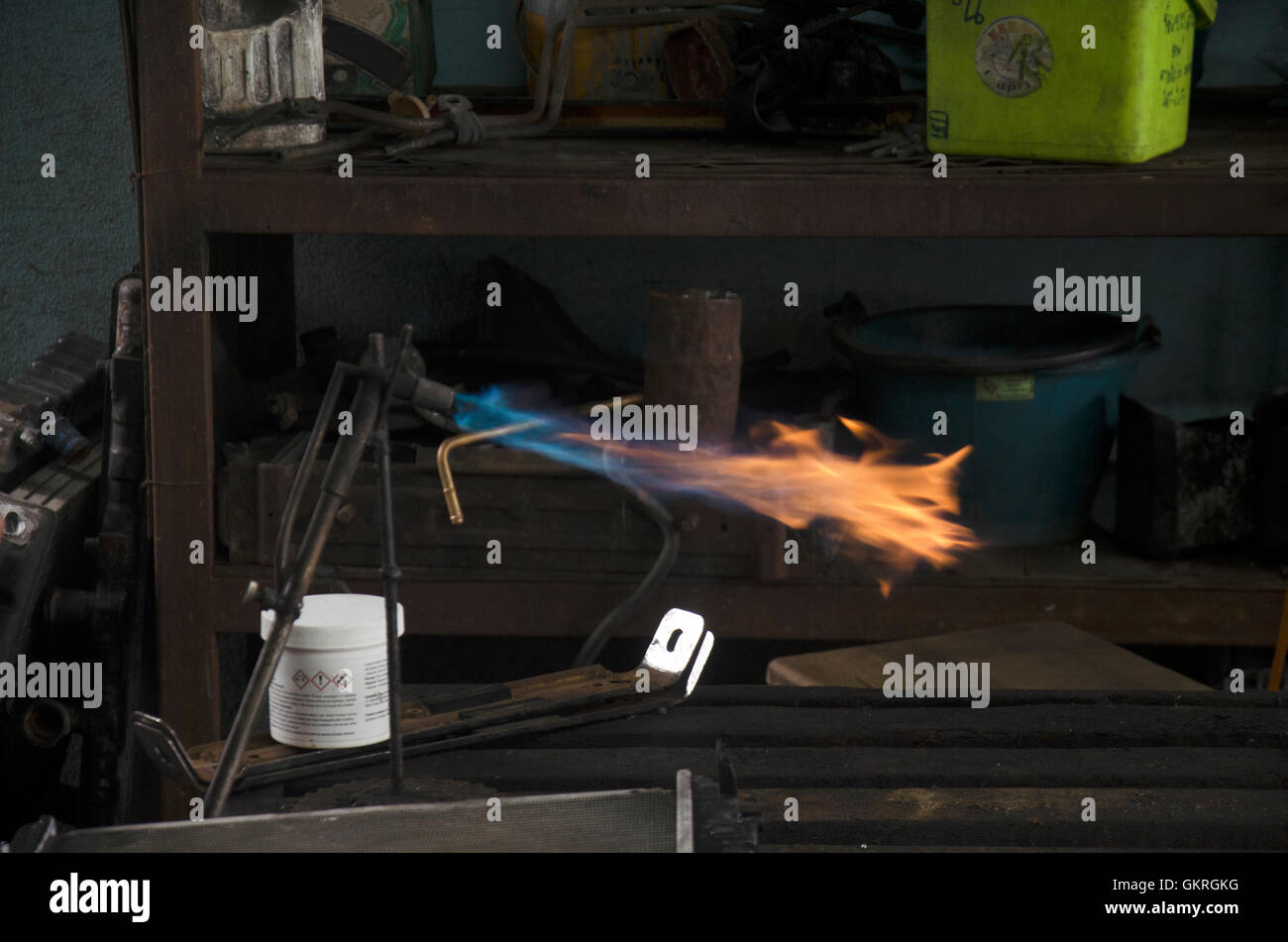 Gas welding for fix and lead solder radiator of car at local garage at ...