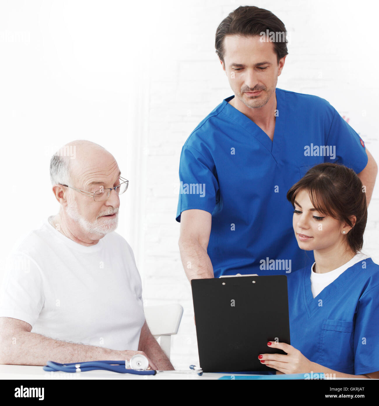 Happy senior patient and doctors in hospital Stock Photo - Alamy