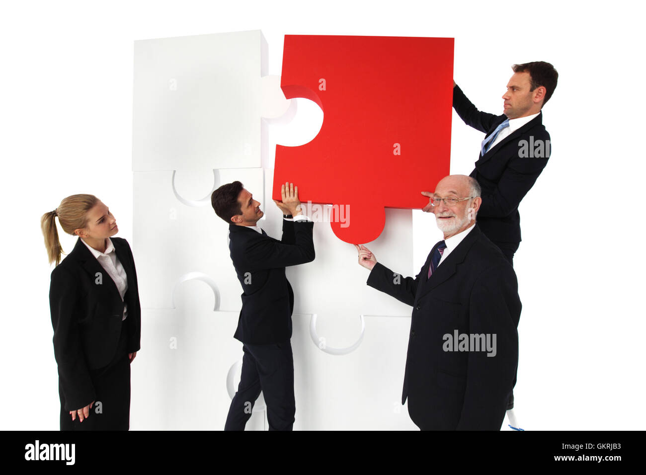 Business people solving problems assembling puzzle isolated on white ...