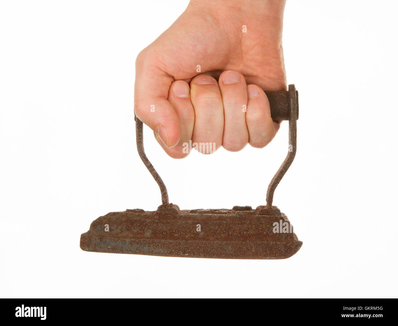 Hand holding an old iron, isolated Stock Photo - Alamy