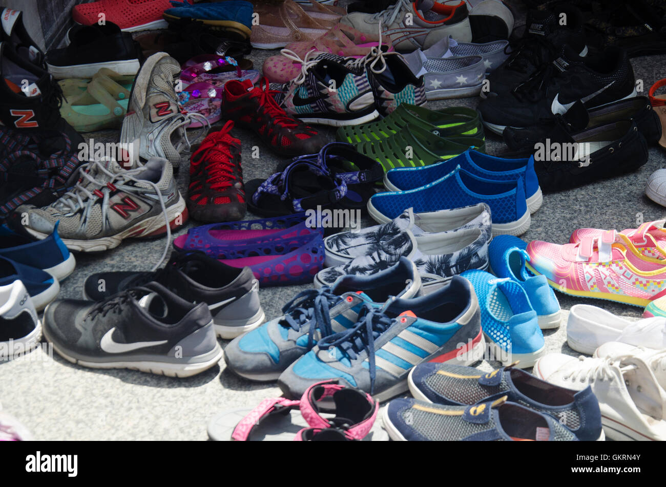Many shoes of thai people and group tour take off the shoes before go ...