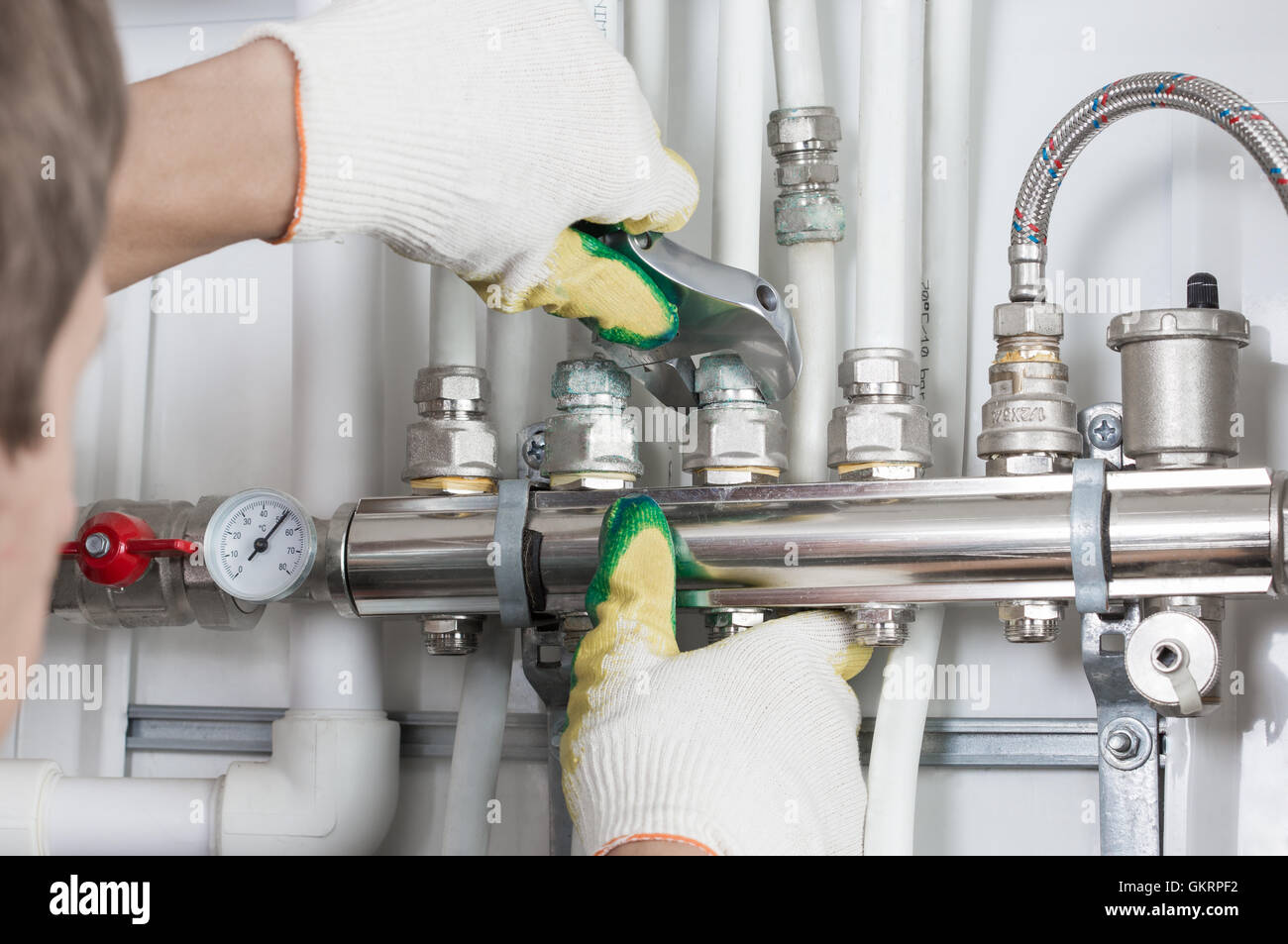 Worker fixing heating system, close up photo Stock Photo - Alamy