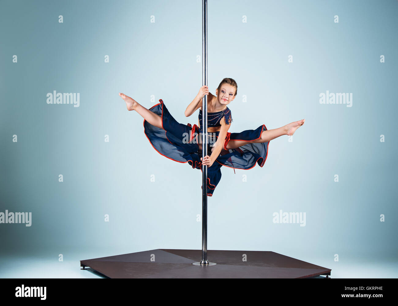 The strong and graceful sports young girl performing acrobatic ...
