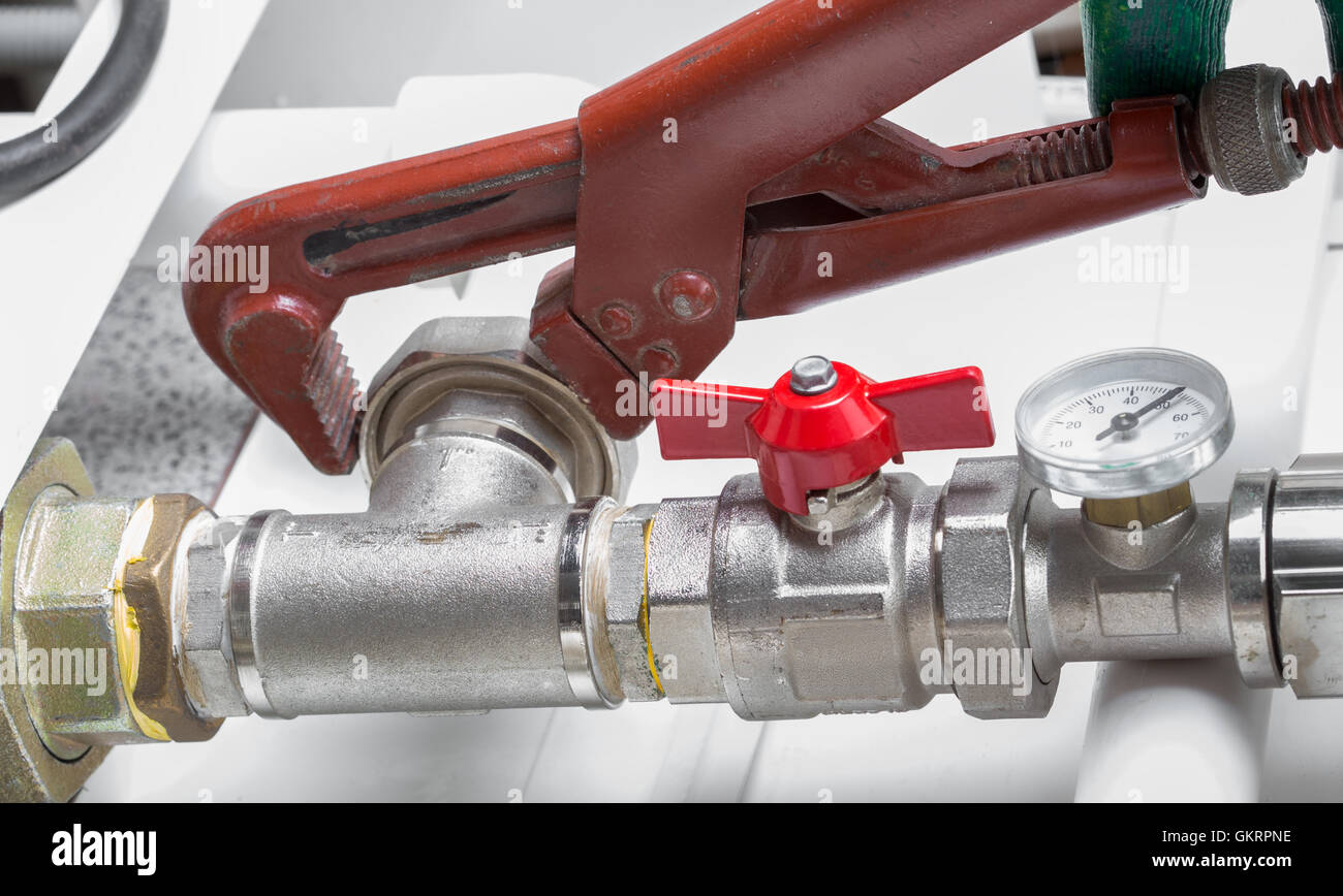 Worker fixing heating system, close up photo Stock Photo - Alamy