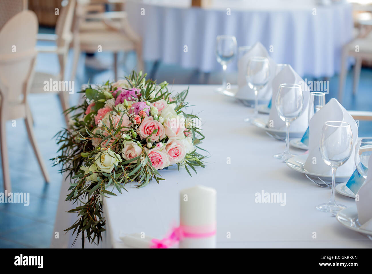 Table set for an event party or wedding reception. Large floral ...