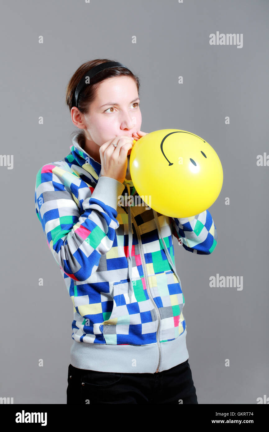 girl inflating a balloon Stock Photo - Alamy
