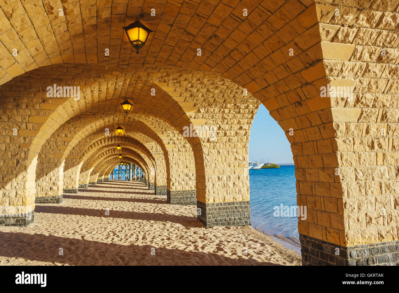 The arched stone colonnade with lanterns Stock Photo - Alamy