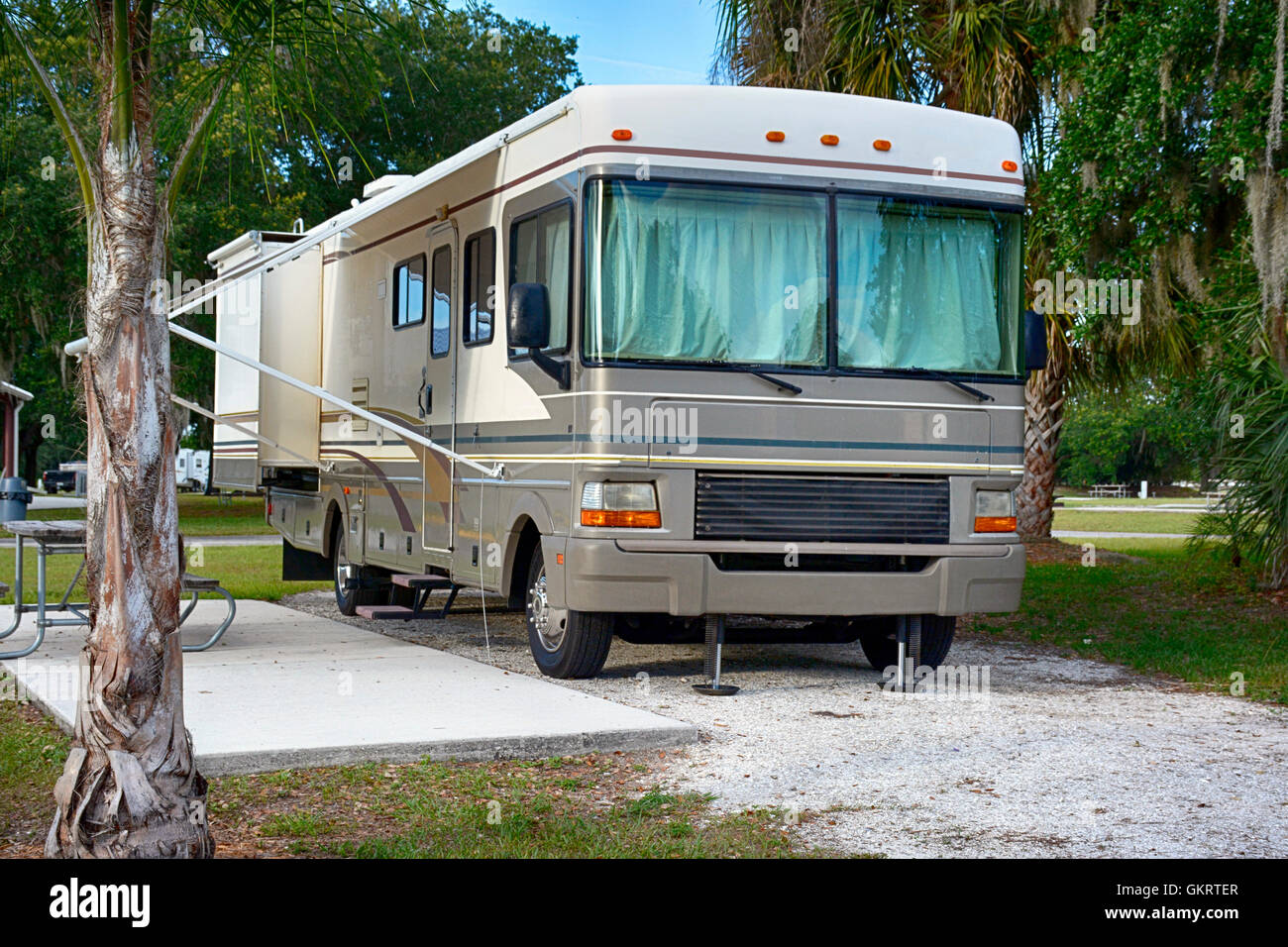 Front and side view of a 32ft class A motorhome with slideouts at a ...