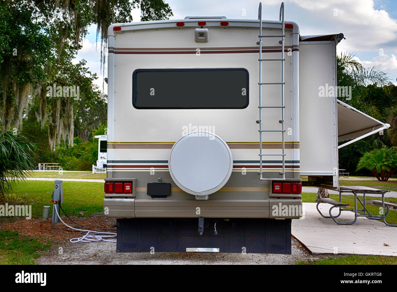 Bedroom slideout and rear view of a 32ft class A motorhome set up at a ...