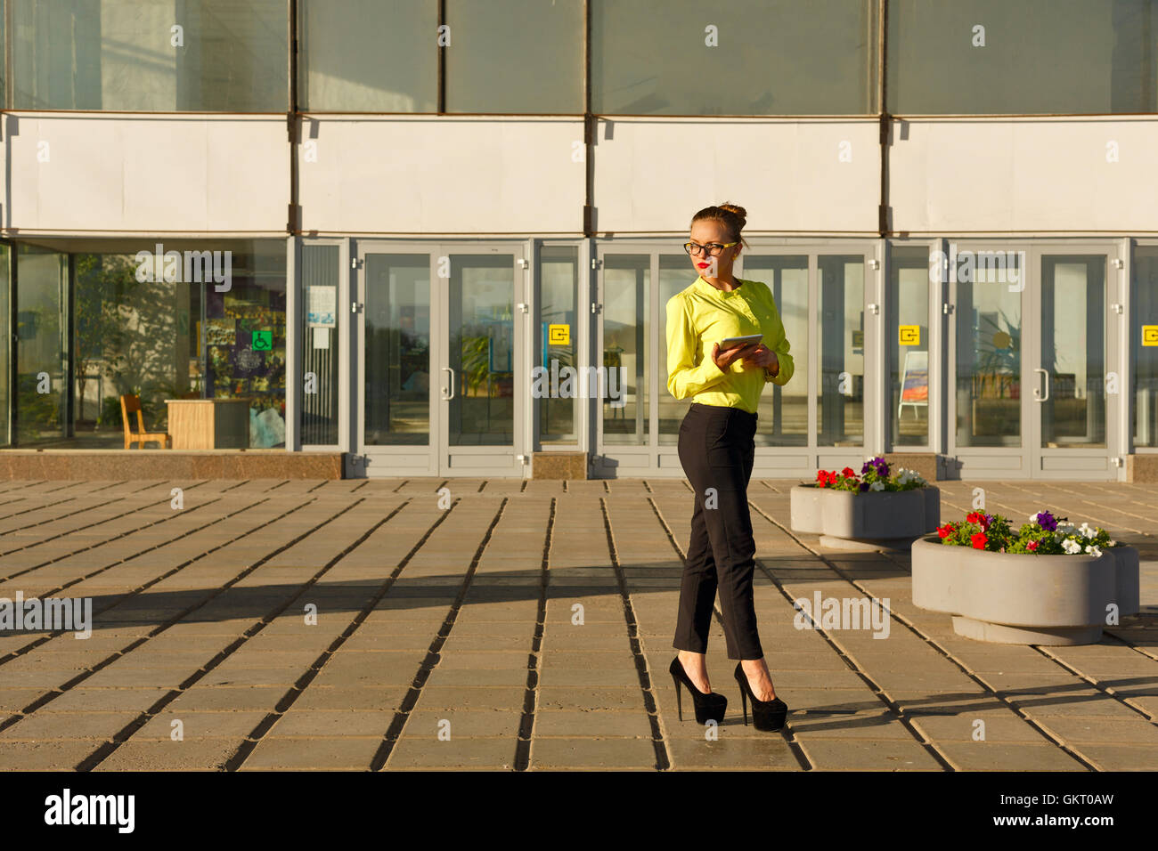 Girl waiting for a letter by e-mail outdoors. Business woman standing ...