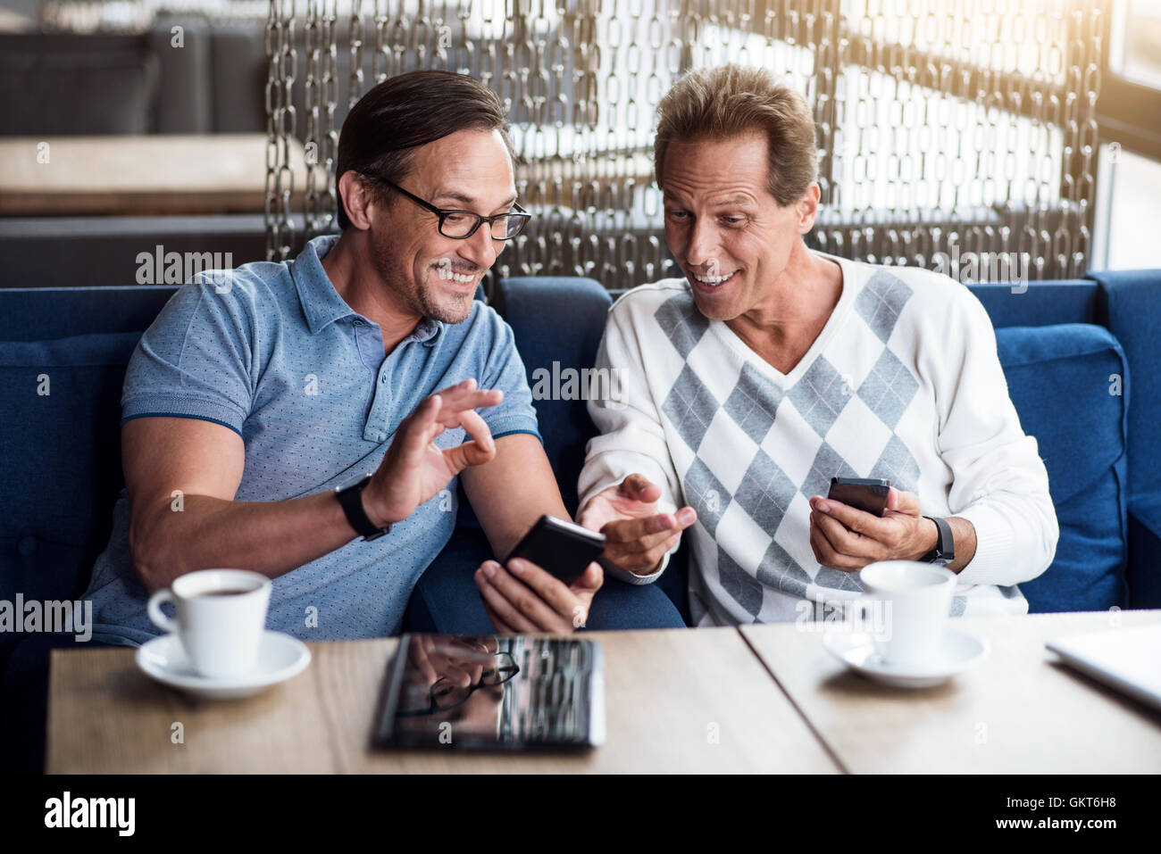 Nice men using smart phones Stock Photo - Alamy