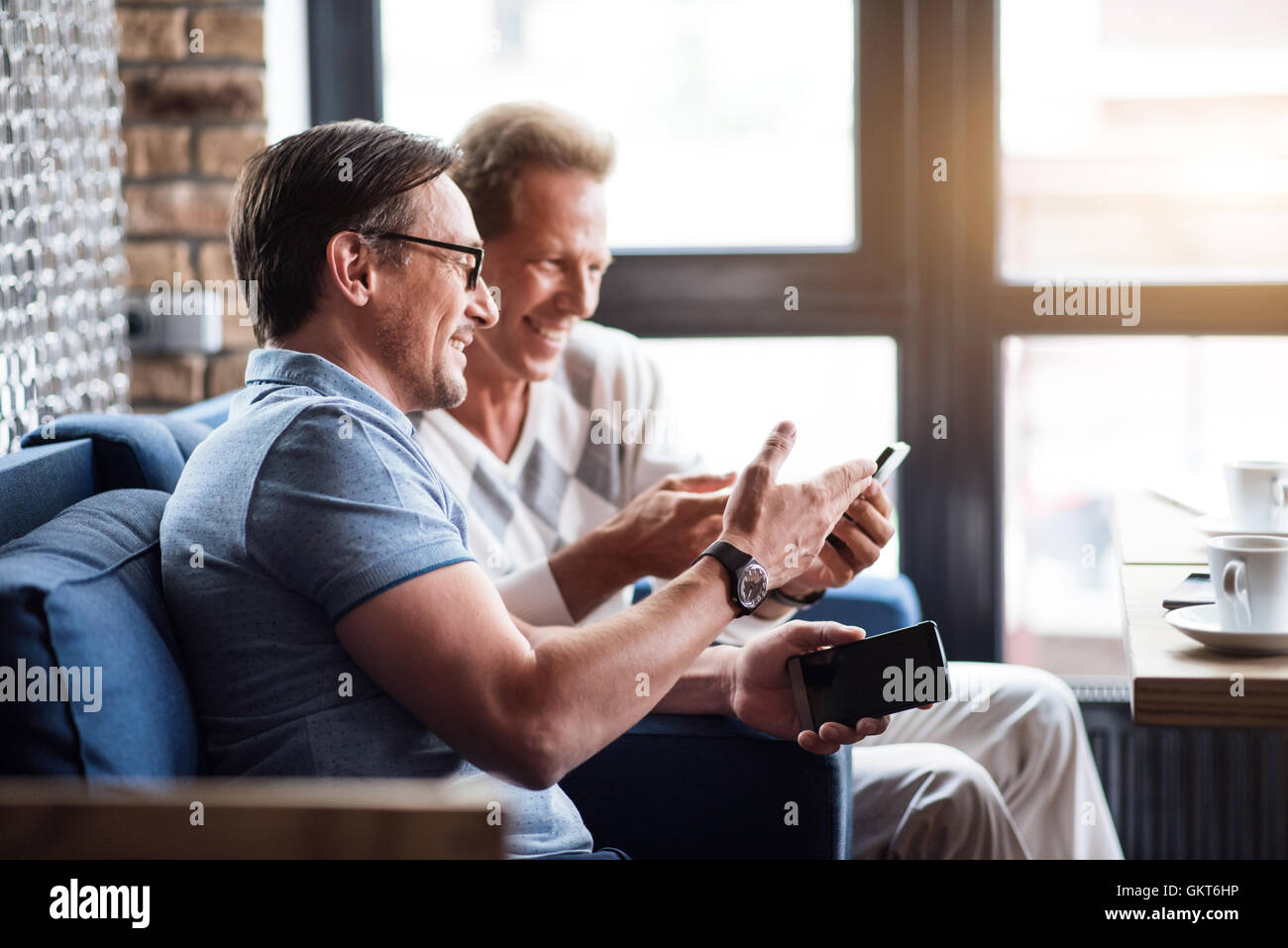 Handsome men using their smart phones Stock Photo - Alamy