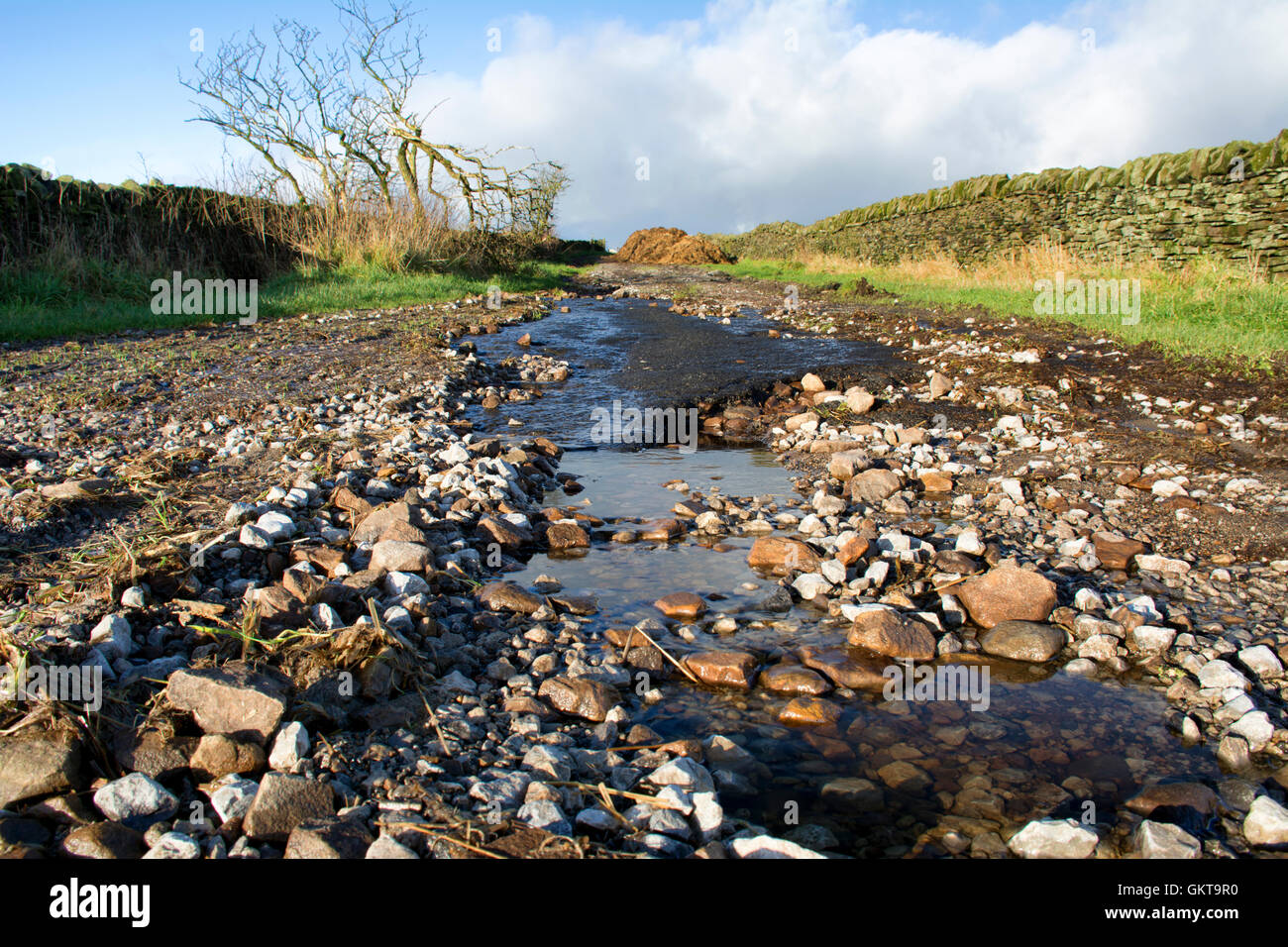 A small stream of water running through some stones on a hill Stock ...