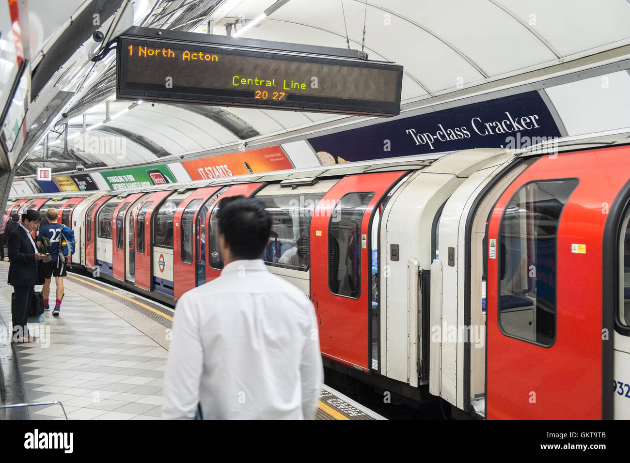 Central Line tube train.Commuters at Tube underground train station ...
