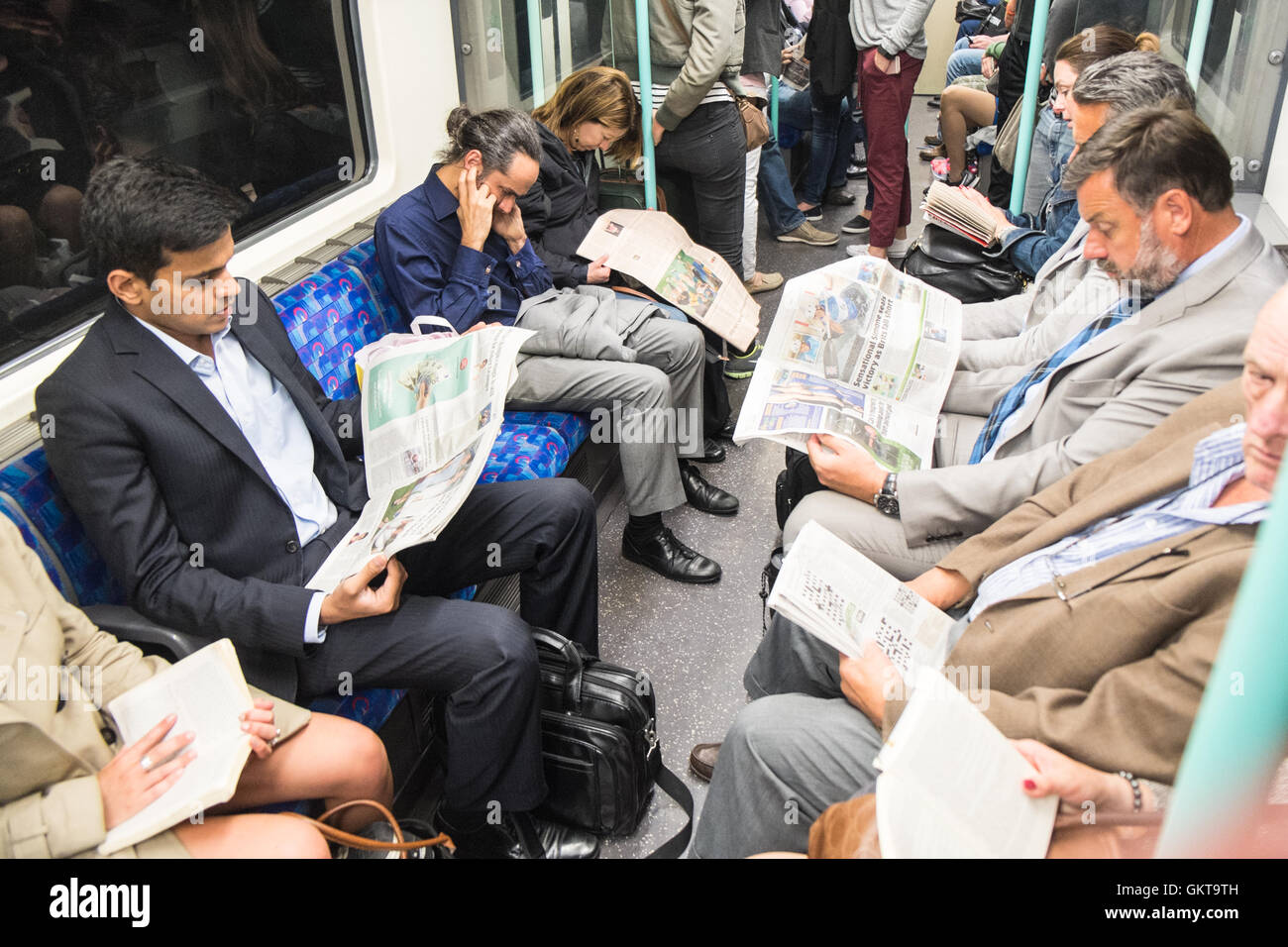 London tube,carriage,Locals reading newspapers and books inside London ...